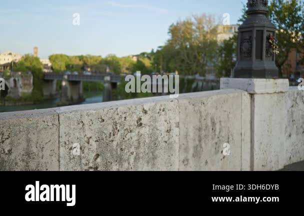 Stone balustrade sharply focused with blurred bokeh river and bridge ...