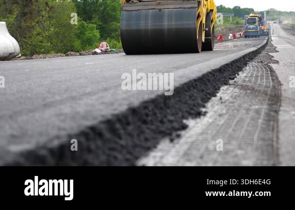 Roller laying new asphalt layer. Special machinery making road ...