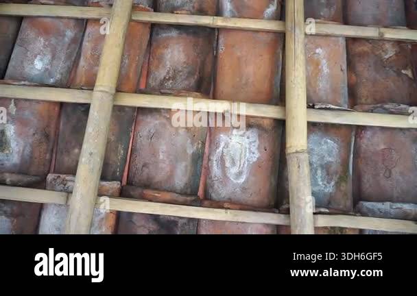 Traditional house roof structure with clay tiles and bamboo framework ...