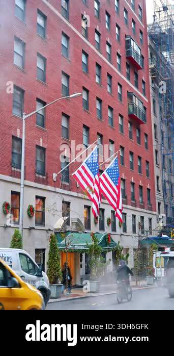 New York, USA, 26 December 2025: Two flags hang on the brick-built ...