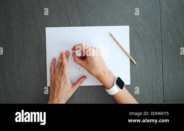 Close up of woman hands erasing pencil doodles with eraser on paper in ...