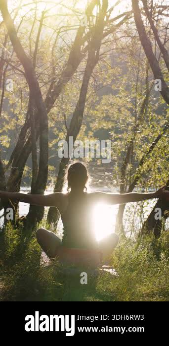 Woman is practicing yoga in nature. Seated gentle easy pose for relief ...