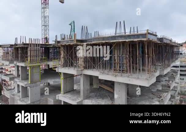 Aerial footage shows detailed construction processes, from pouring ...