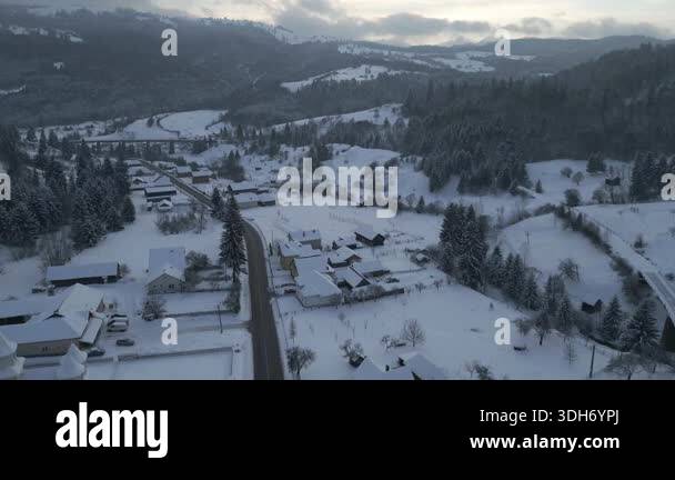 Drone aerial footage slowly ascending and moving forward above snowy ...