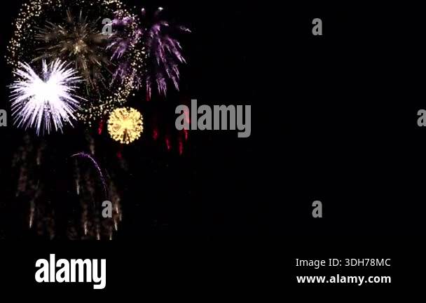 Golden fireworks exploding in a night sky as a festive background for ...