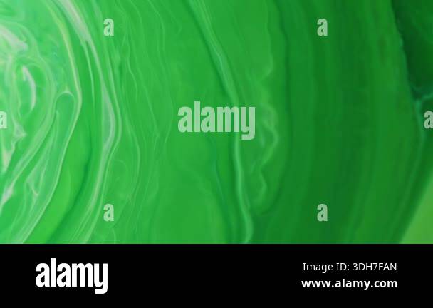 Ink drip. Liquid mix. Defocused green colorful splash water spill ...