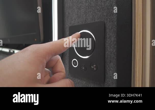 User rotates the illuminated dimmer dial on a smart lighting control ...