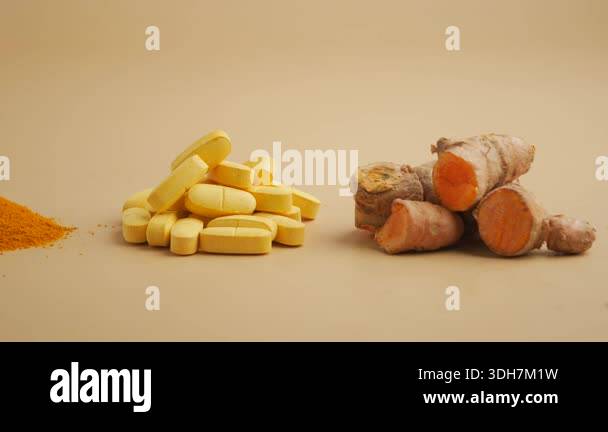 Turmeric Supplements on a color background Stock Video Footage - Alamy