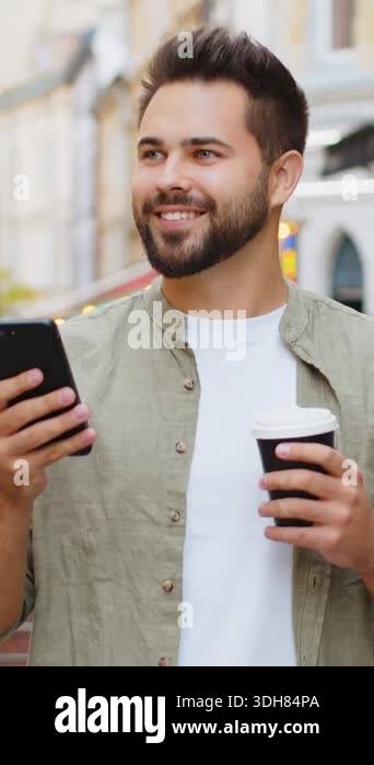 Happy smiling man use smartphone typing text messages browsing internet ...