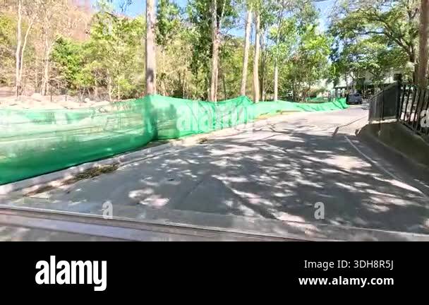 Golf cart travels through scenic zoo pathway Stock Video Footage - Alamy