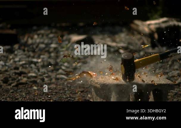 Large Heavy Sledgehammer Smashing an Upside Down Amber Glass Goblet on ...