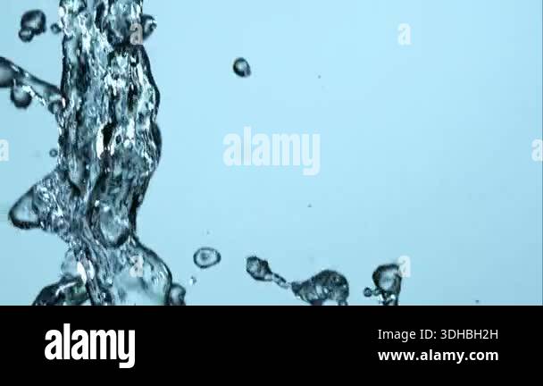Powerful water splash bursting upward with suspended droplets creating ...