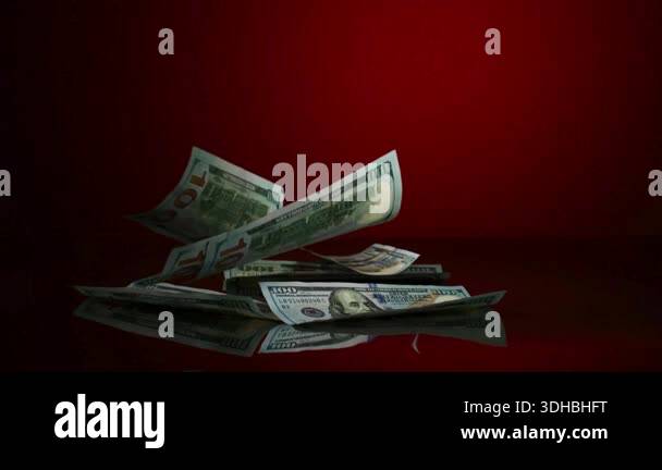 One hundred dollar bills currency banknotes falling onto a bright red ...