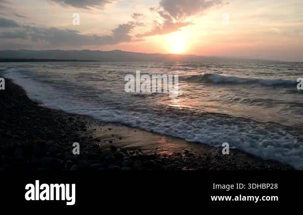 A majestic 4K drone sequence capturing the final moments of sunset over ...