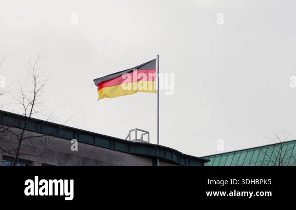 German flag on a government building rooftop. Symbol of the country ...