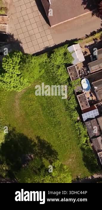 Top down drone shot flying over a green residential neighborhood with ...