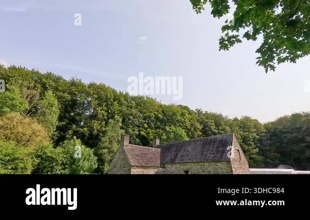 Stone building surrounded by lush green landscape Stock Video Footage ...