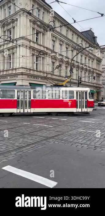 Trams navigating the historic streets of Pragues Old Town, capturing ...