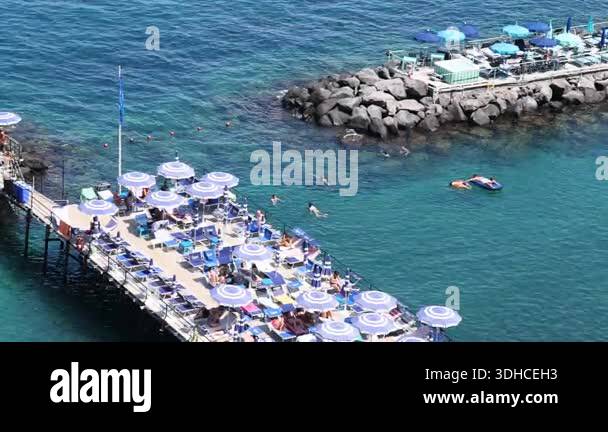 People relaxing and swimming at Leonelli Beach Stock Video Footage - Alamy