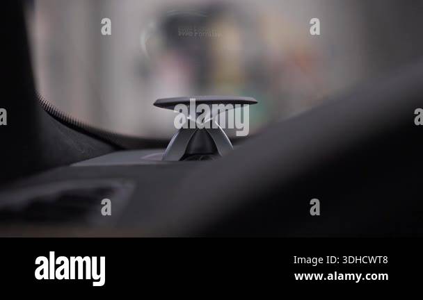 Tight interior shot shows a pop up center dash tweeter rising, steering ...