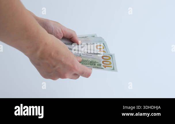 Hands are counting several hundred dollar bills, illustrating the ...