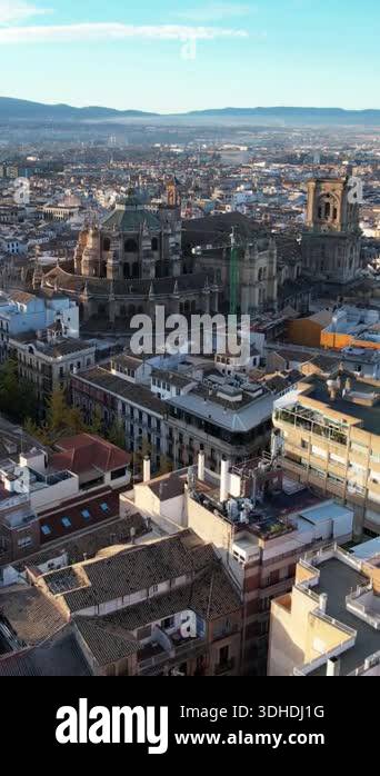 Drone view showcases the urban landscape of Granada. Buildings houses ...