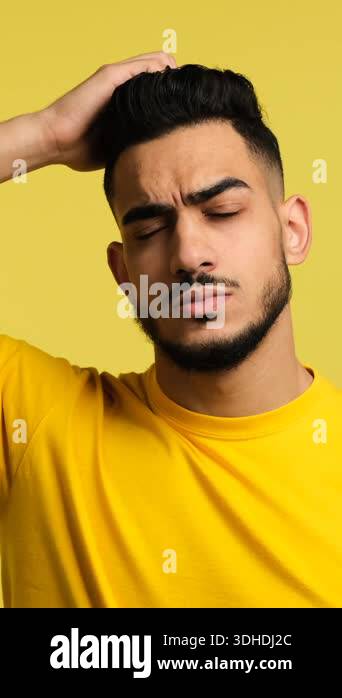 Vertical video of a thoughtful young man having a eureka moment ...