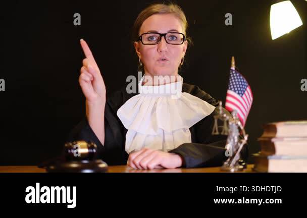 Female judge making a ruling and sentencing in the courtroom, waving a ...