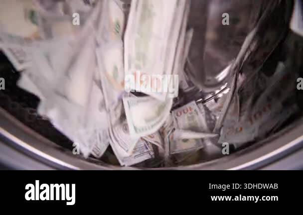 US dollar banknotes spinning inside washing machine in slow motion for ...