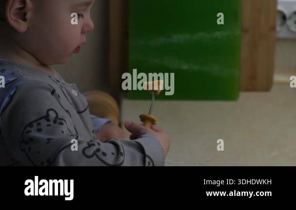 Toddler Eating with Fork in Pajamas Close Up Stock Video Footage - Alamy