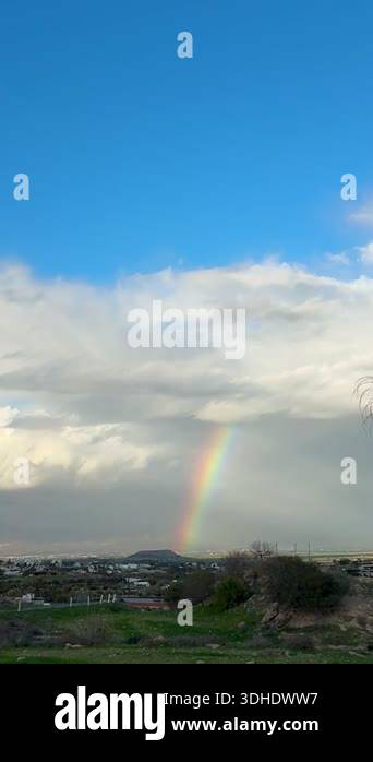 Rainbow over landscape. Rainbow over landscape under cloudy sky Stock ...