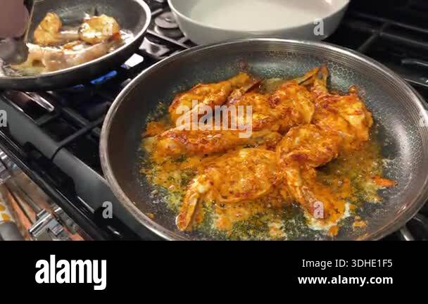 Juicy shrimp fully cooked in a thick orange spice sauce, glistening ...