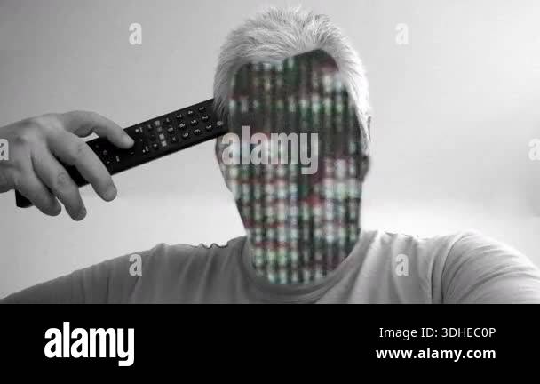 Man whose face is replaced by television static holding a remote ...