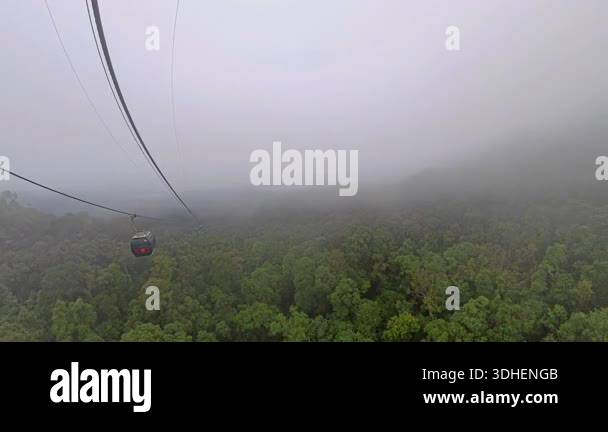 Cable Car Moving Through Dense Fog Above Forest During Cloudy Ascent to ...