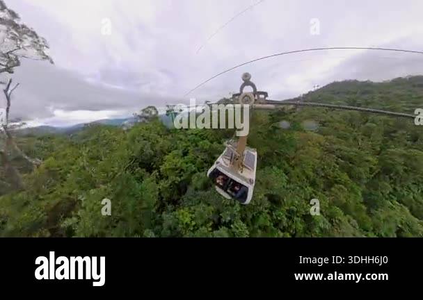 Cable Car Moving Above Mountain Forest Emerging from Fog Viewed in Wide ...