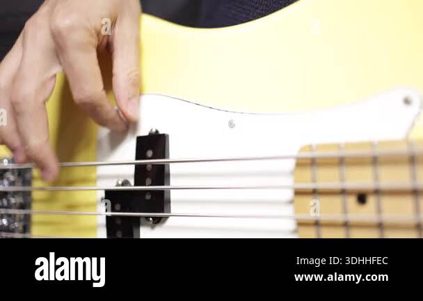 Musician playing bass guitar strings close-up, music performance Stock ...