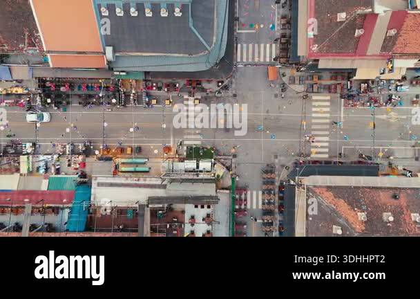 Top-down aerial view of a busy urban intersection with cars, buses and ...