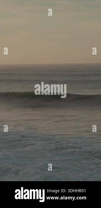 Powerful ocean wave forming and crashing in slow motion during sunset ...