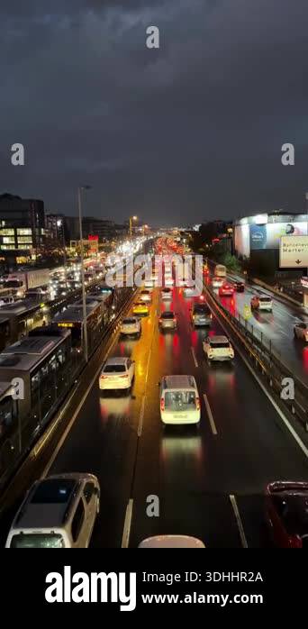 Night view of heavy traffic on a busy city highway with glowing light ...