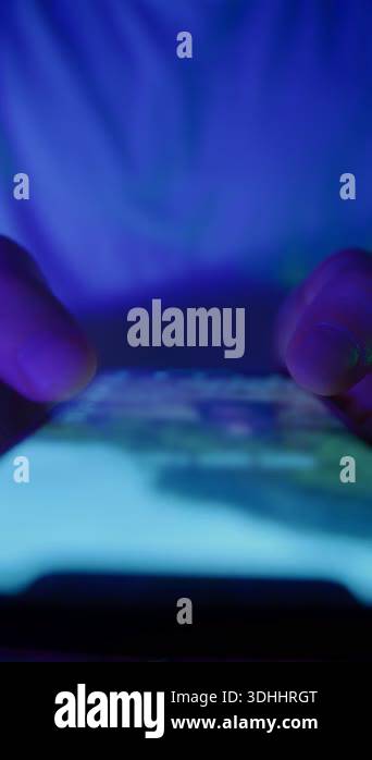 Macro view of man fingers move across a glowing touchscreen, scrolling ...