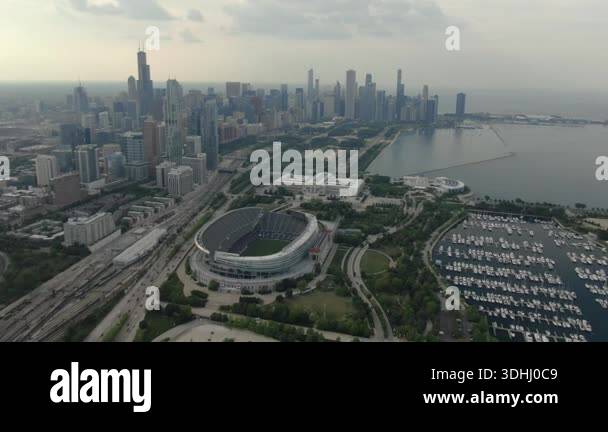 An aerial view of Soldier Field curves along Lake Michigan, its ...