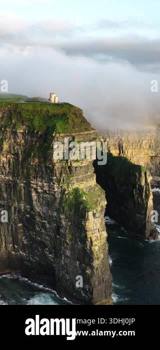Aerial footage of coastal cliffs shrouded in low clouds. Picturesque ...