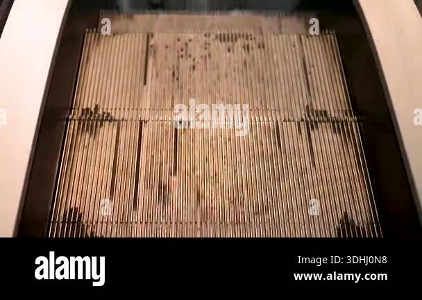 Close-up of moving steps on an escalator descending in a shopping ...