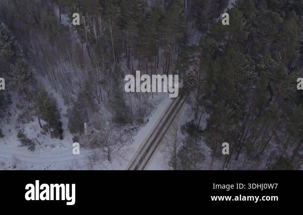 Aerial top down view shows a snow lined road near Nowy Lubiel, Poland ...