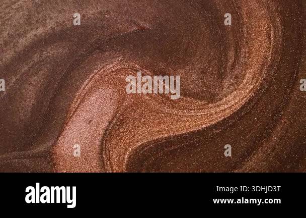 Mesmerizing video of fluid golden paint coiling into an elegant ...