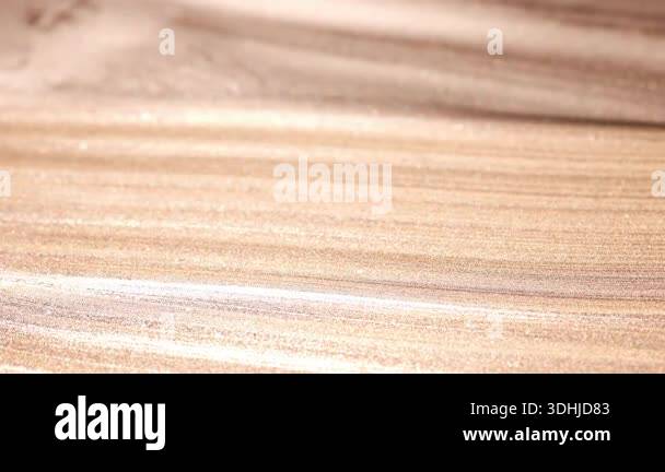 Shallow depth of field shot of bright golden paint surface ...