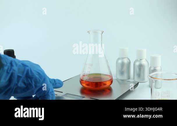 chemical beaker or flask is used on white table with blotting paper ...