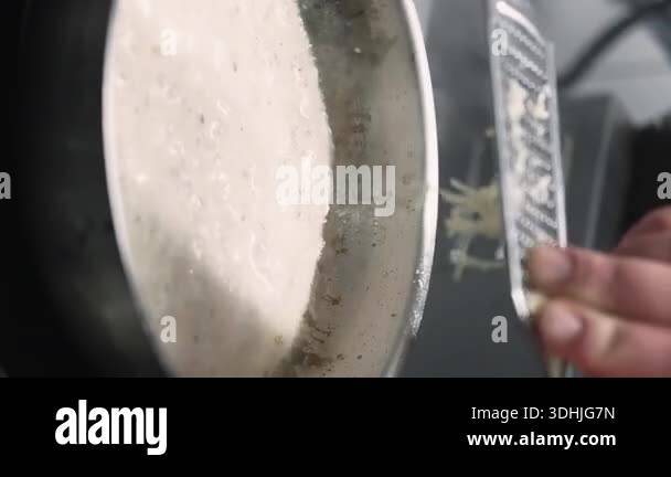 Vertical video. Grinding garlic. Cooking sauce. Chefs hands rubbing raw ...