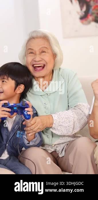 Multigenerational family enjoys video gaming together, creating joyful ...