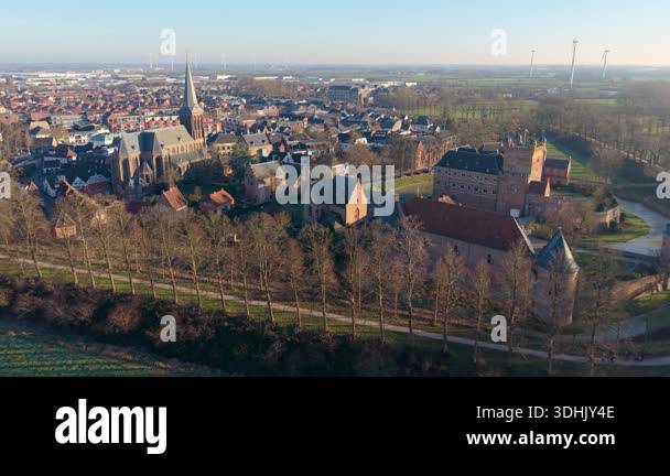 Aerial view of a European town where a tall church spire, fortified ...